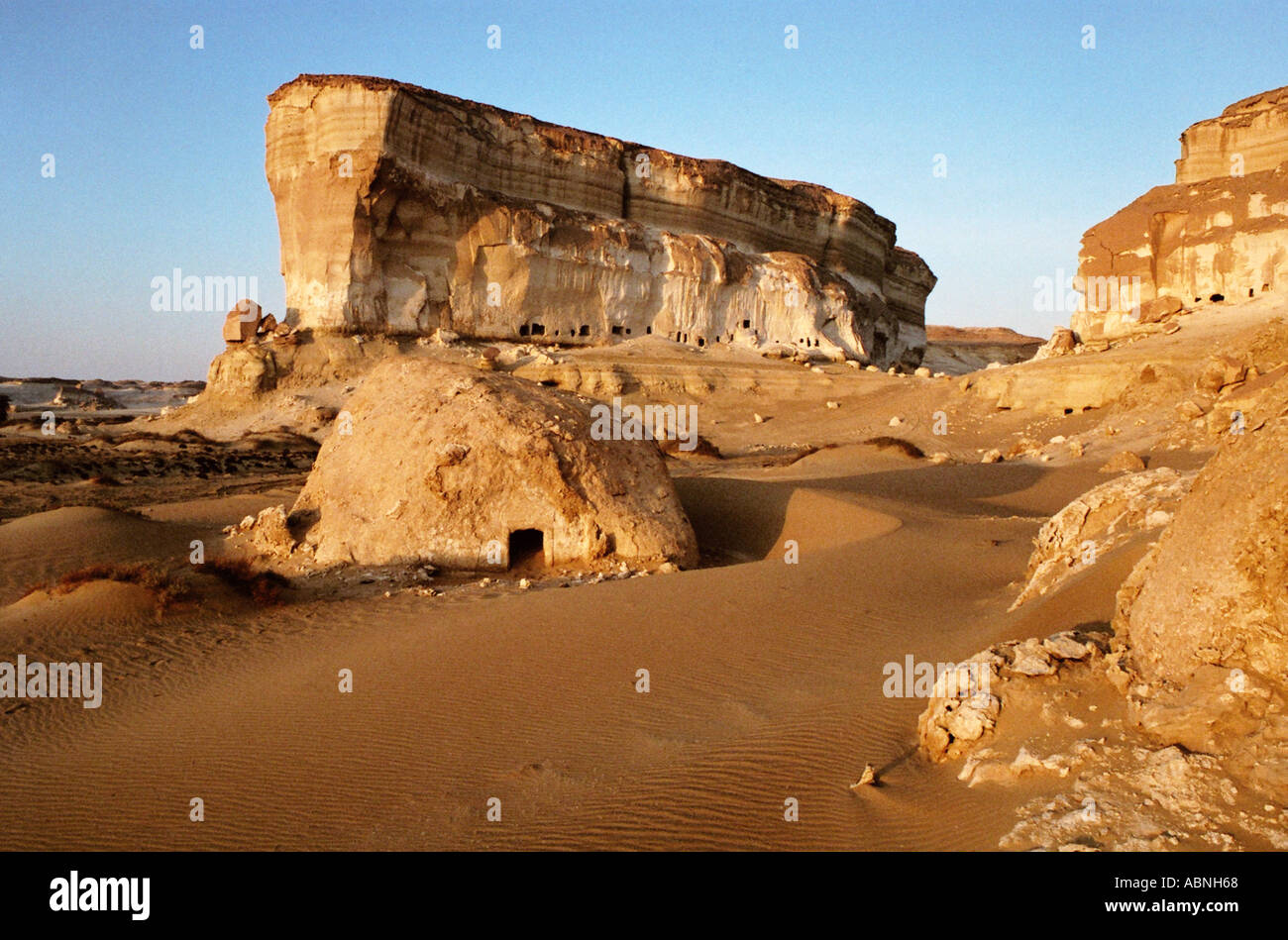 Tombs cut into the cliff face at El Arag oasis Western Desert Egypt ...