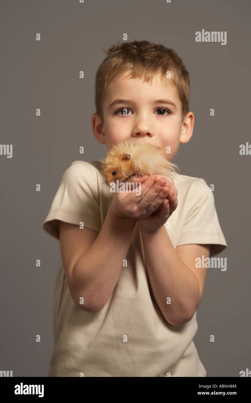 Little Boy Holding Hamster Stock Photo - Alamy