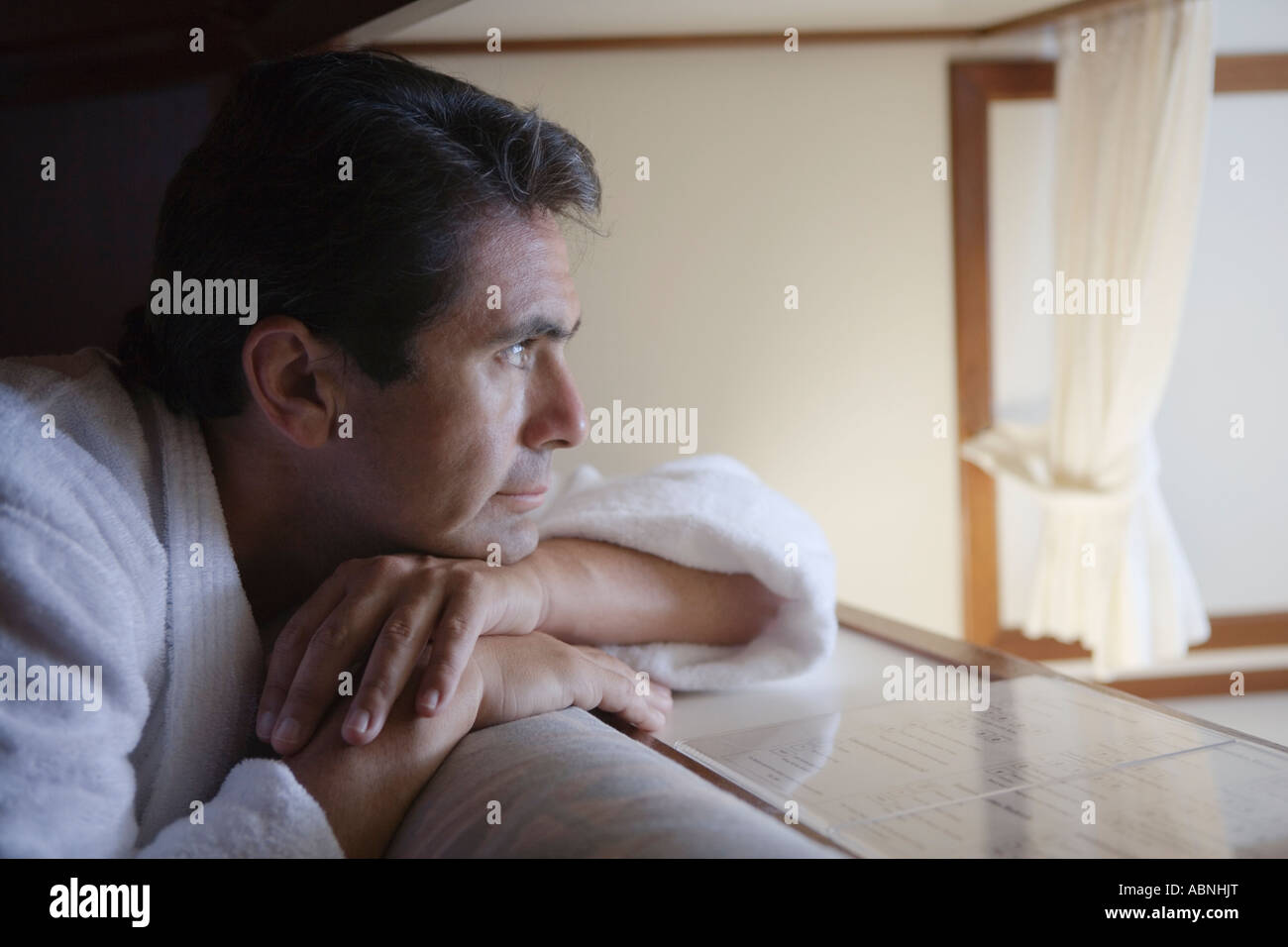 Man looking out window Stock Photo - Alamy