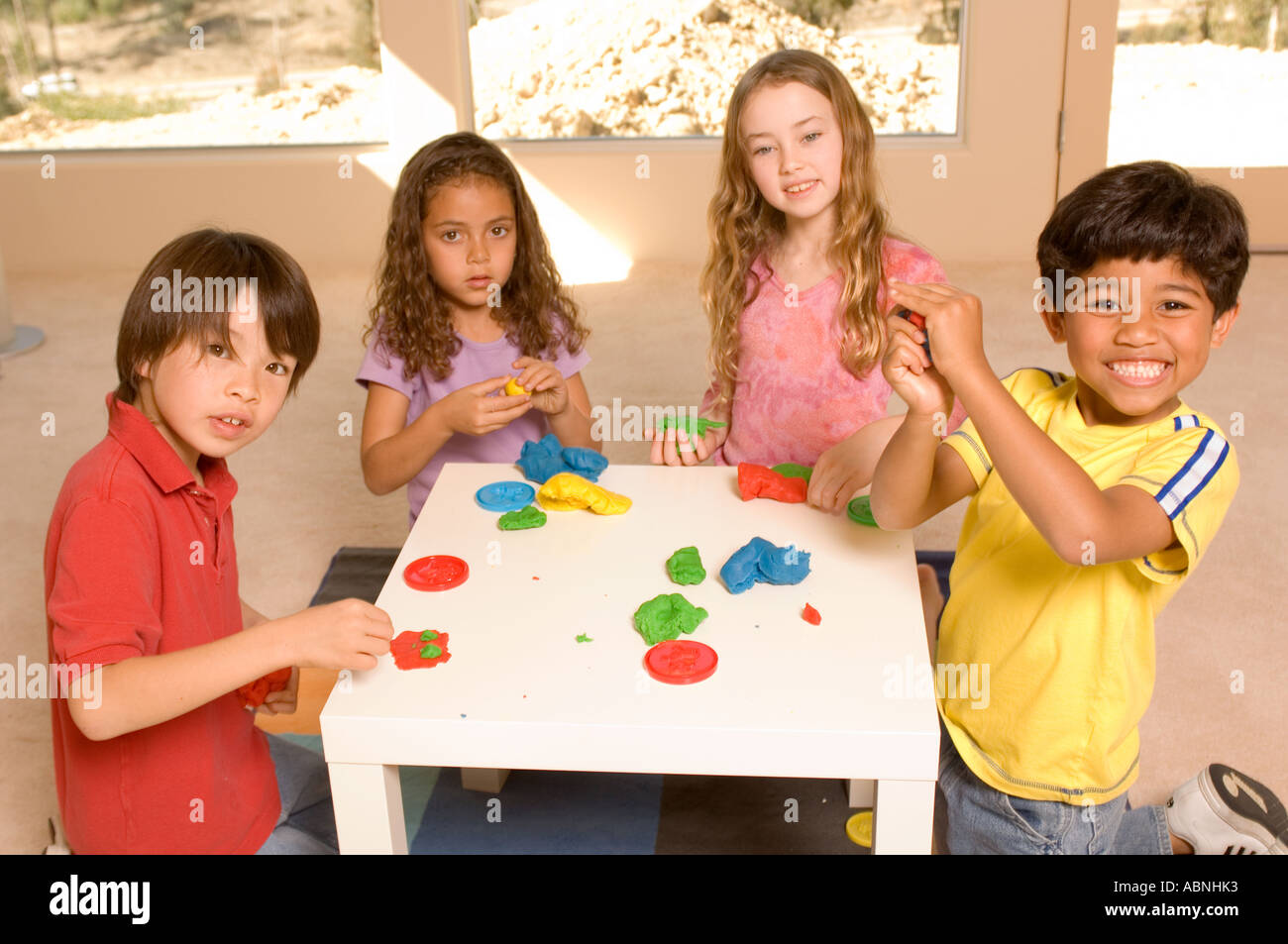 Portrait of children playing with playdough Stock Photo - Alamy