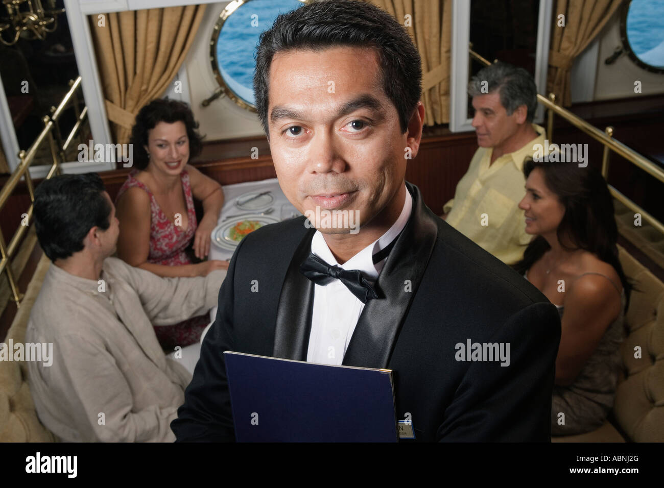 Waiter smiling in restaurant Stock Photo - Alamy
