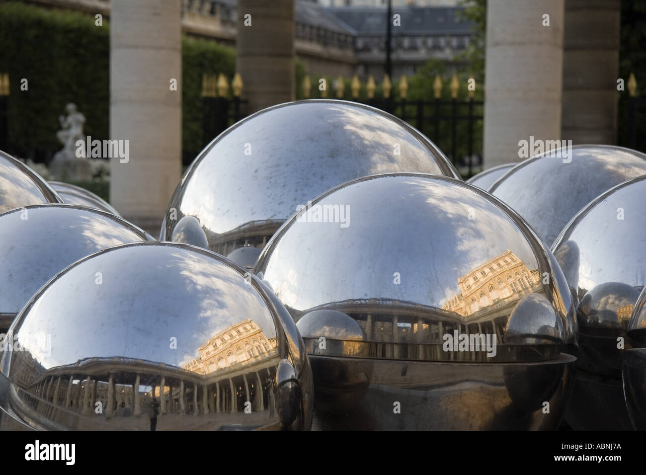 Shiny chrome silver spheres reflect the facade of the Palais Royal ...