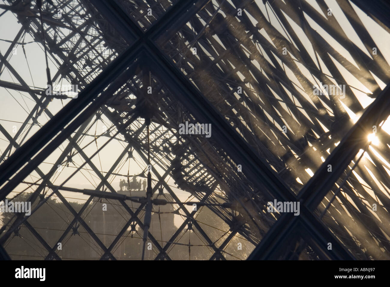 The Arc de Triomphe seen through the glass Pyramid at Musee du Louvre ...