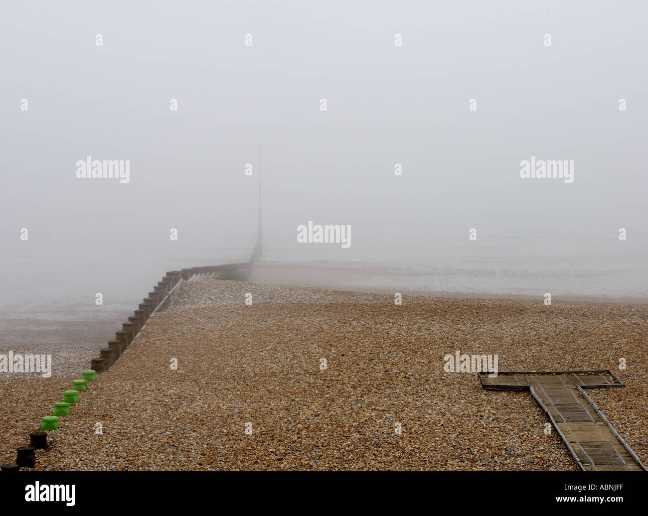 Sea mist pebble beach and breakwater Stock Photo - Alamy