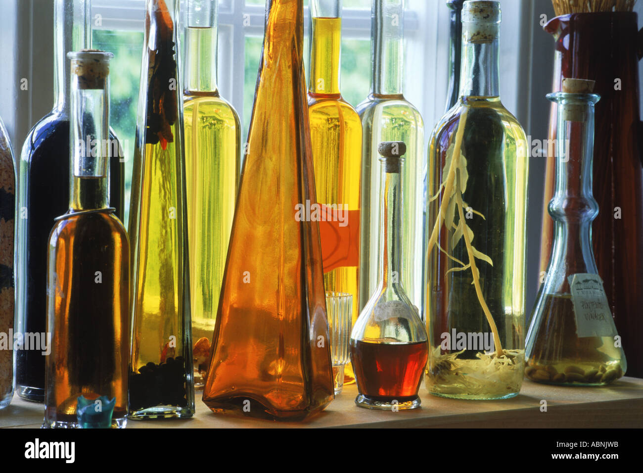 Bottles of various shapes and colors filled with vinegar and oils Stock ...