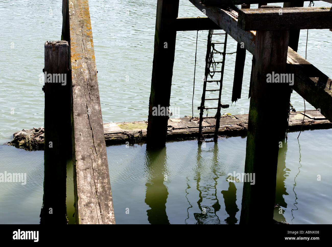 Derelict wooden jetty and mooring lines Stock Photo - Alamy