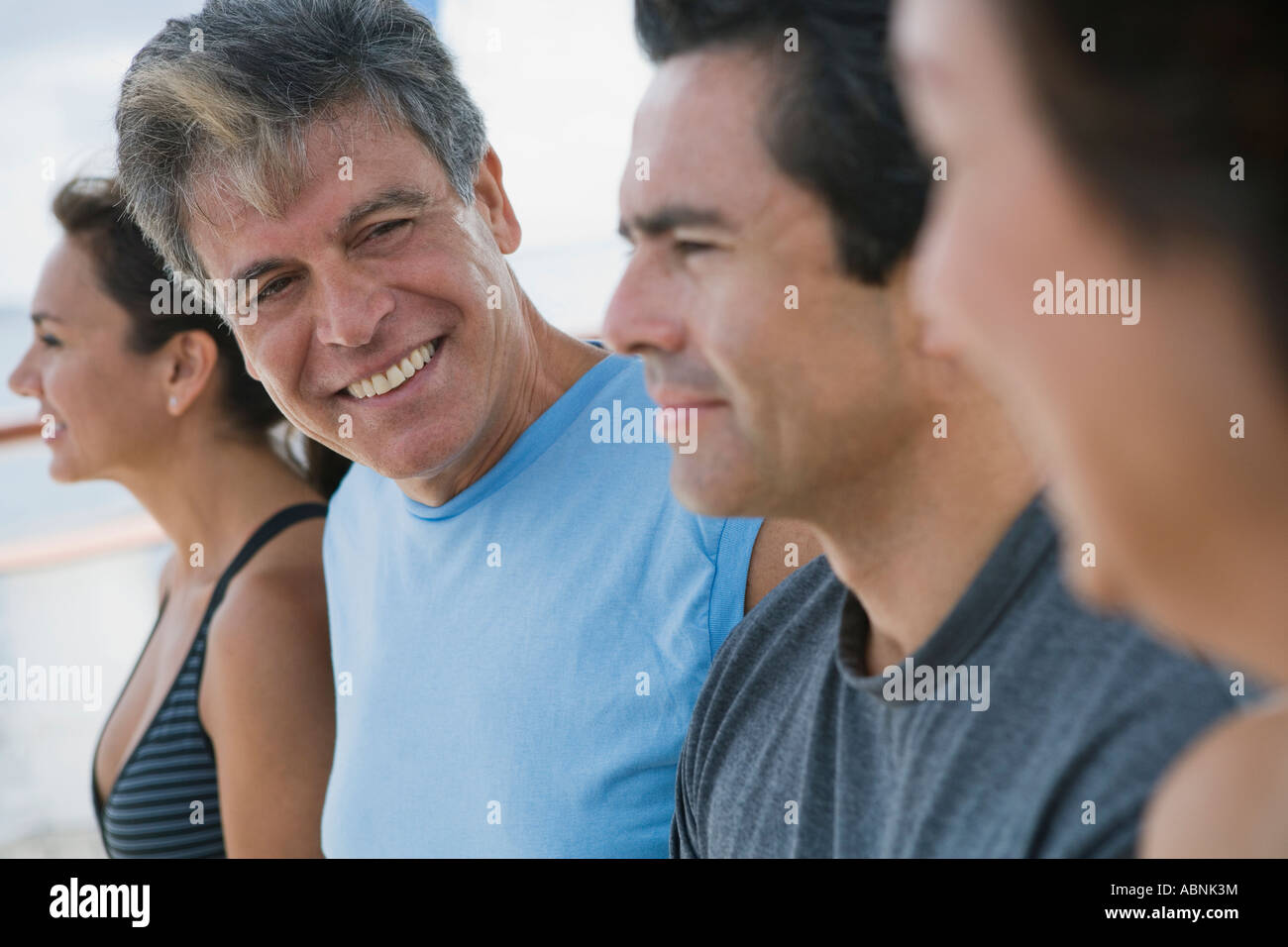People sitting in a row Stock Photo - Alamy