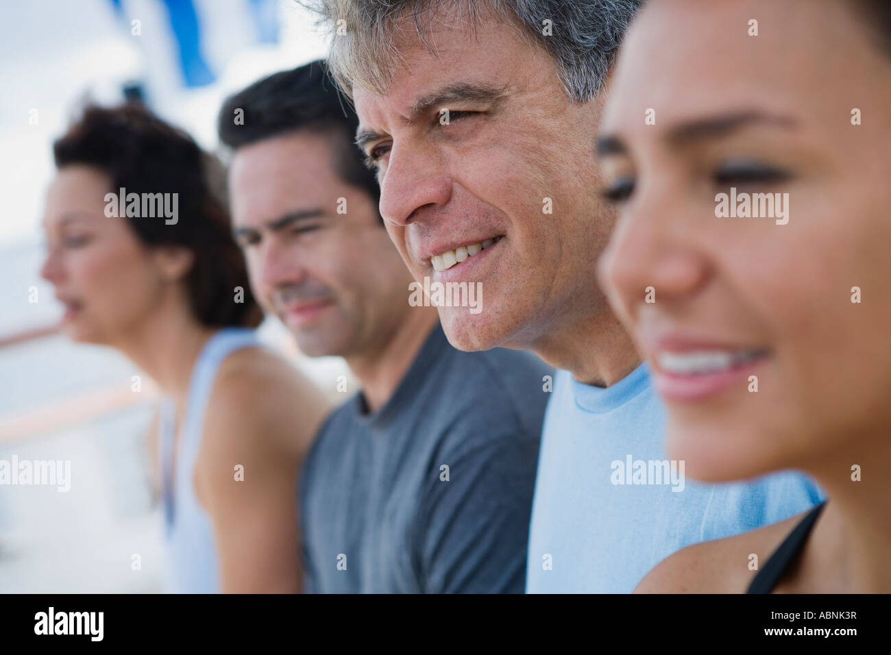 People sitting in a row Stock Photo - Alamy