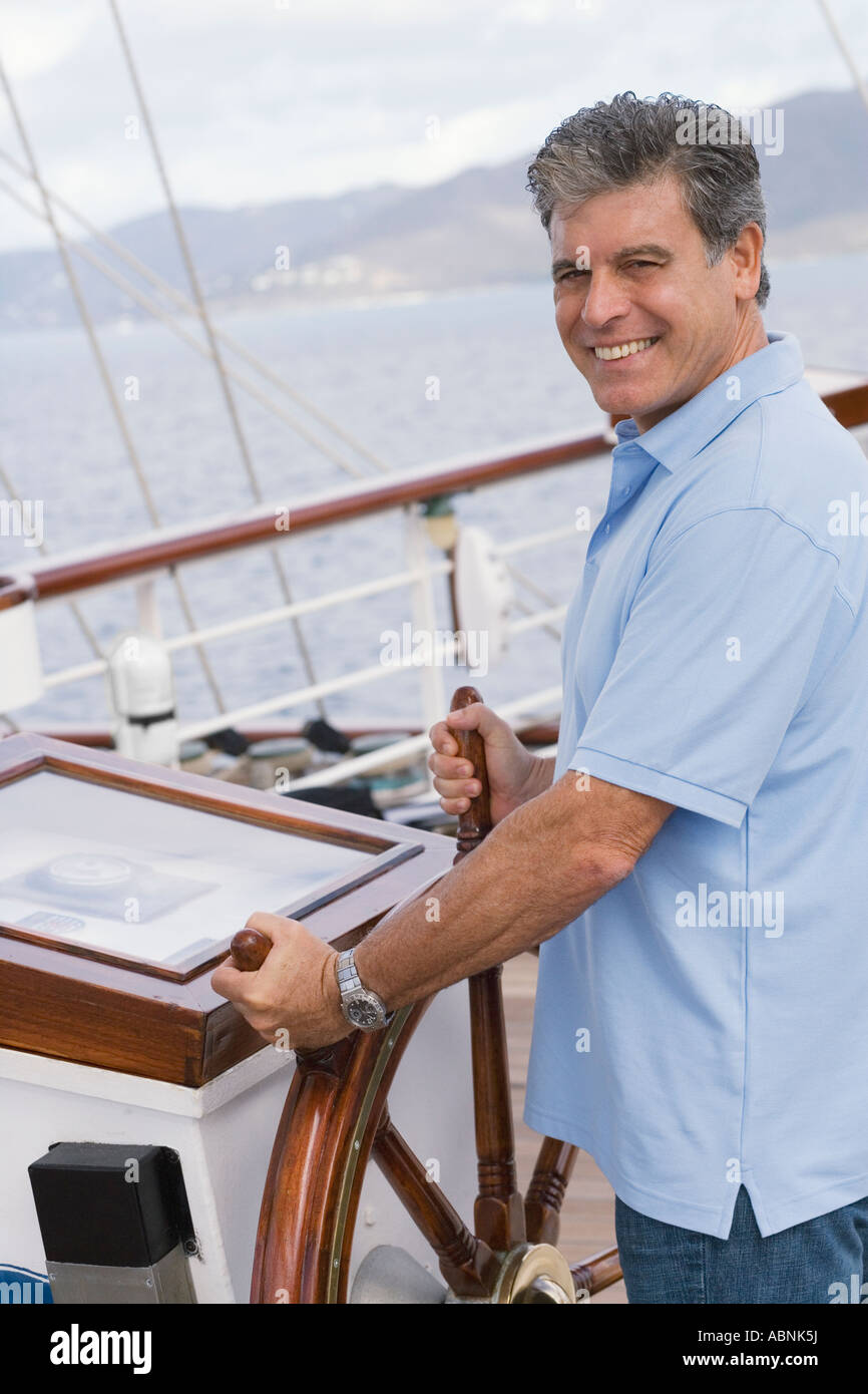Man steering ship Stock Photo - Alamy