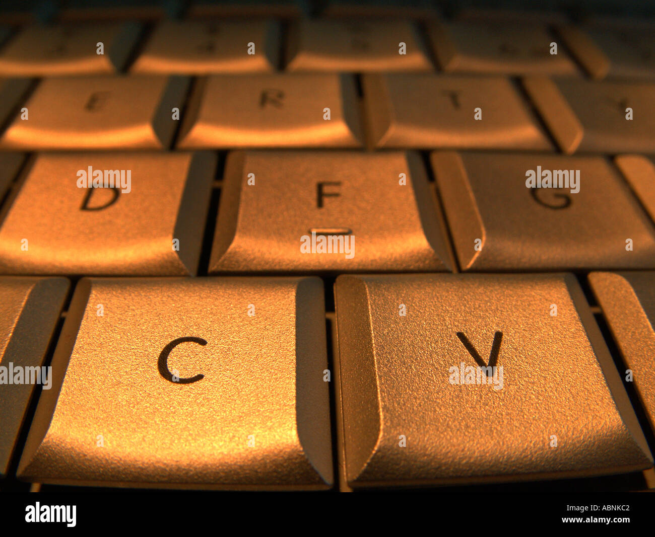 Metallic computer keyboard Focus on the characters CV Curriculum Vitae ...