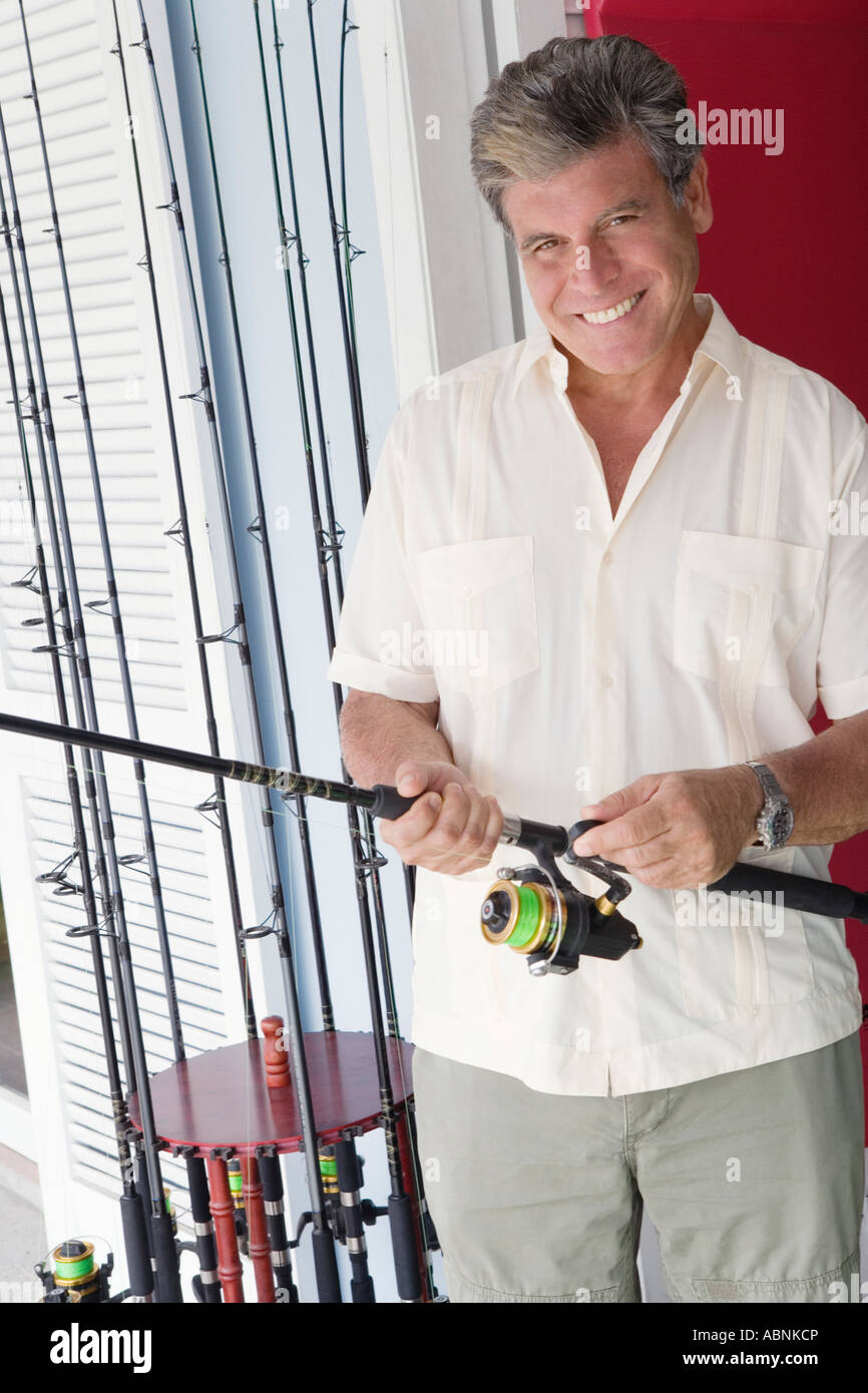 Man holding fishing rod Stock Photo - Alamy