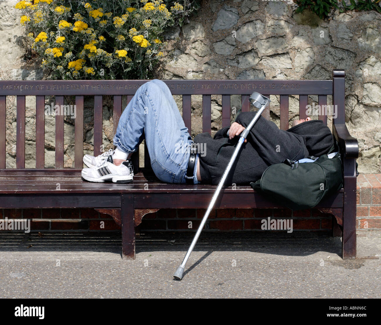 Young man sleeping on park bench Eastbourne Stock Photo - Alamy