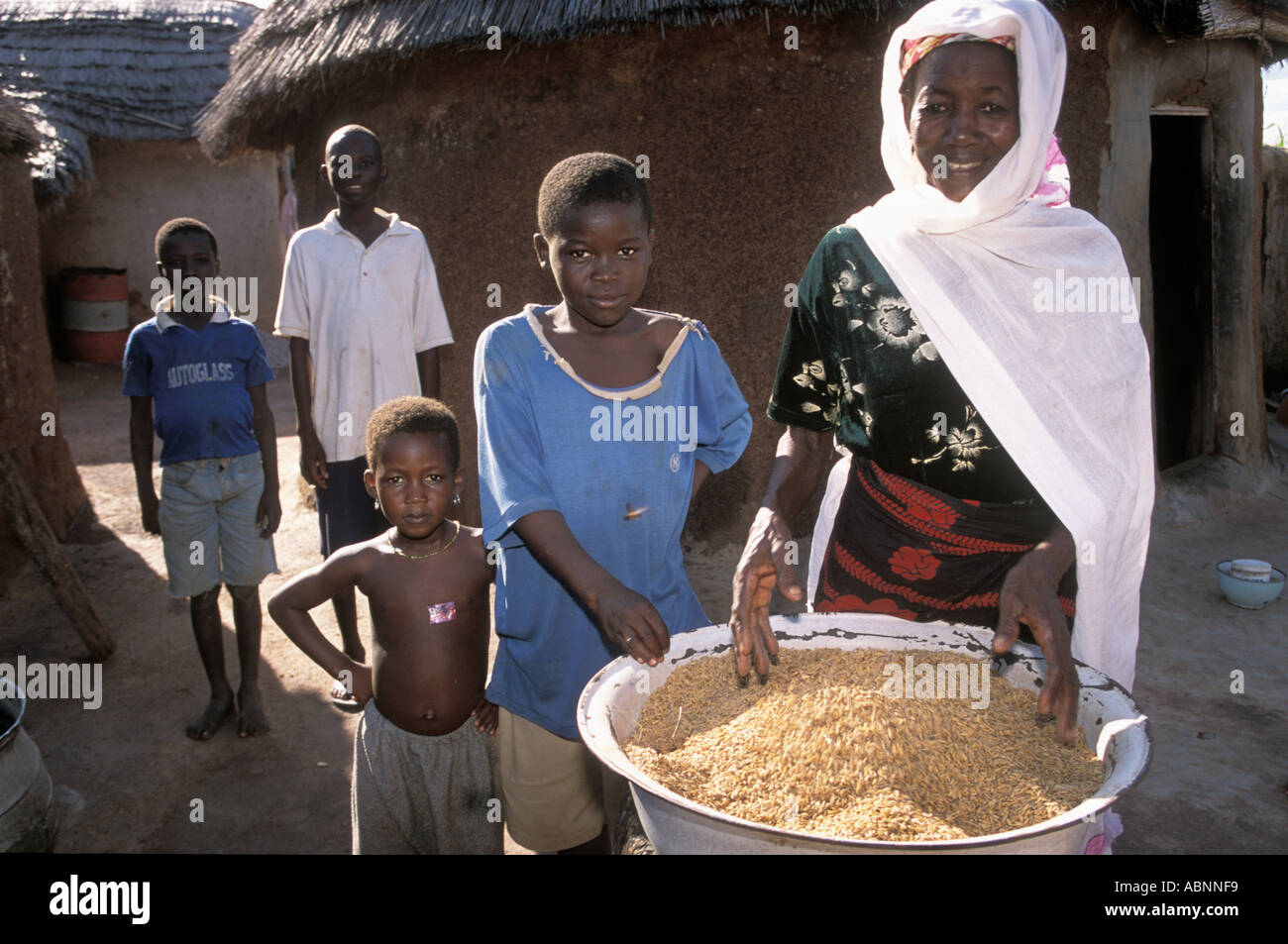 Ghanaian woman demonstrates her bowl of rice like all local farmers is ...