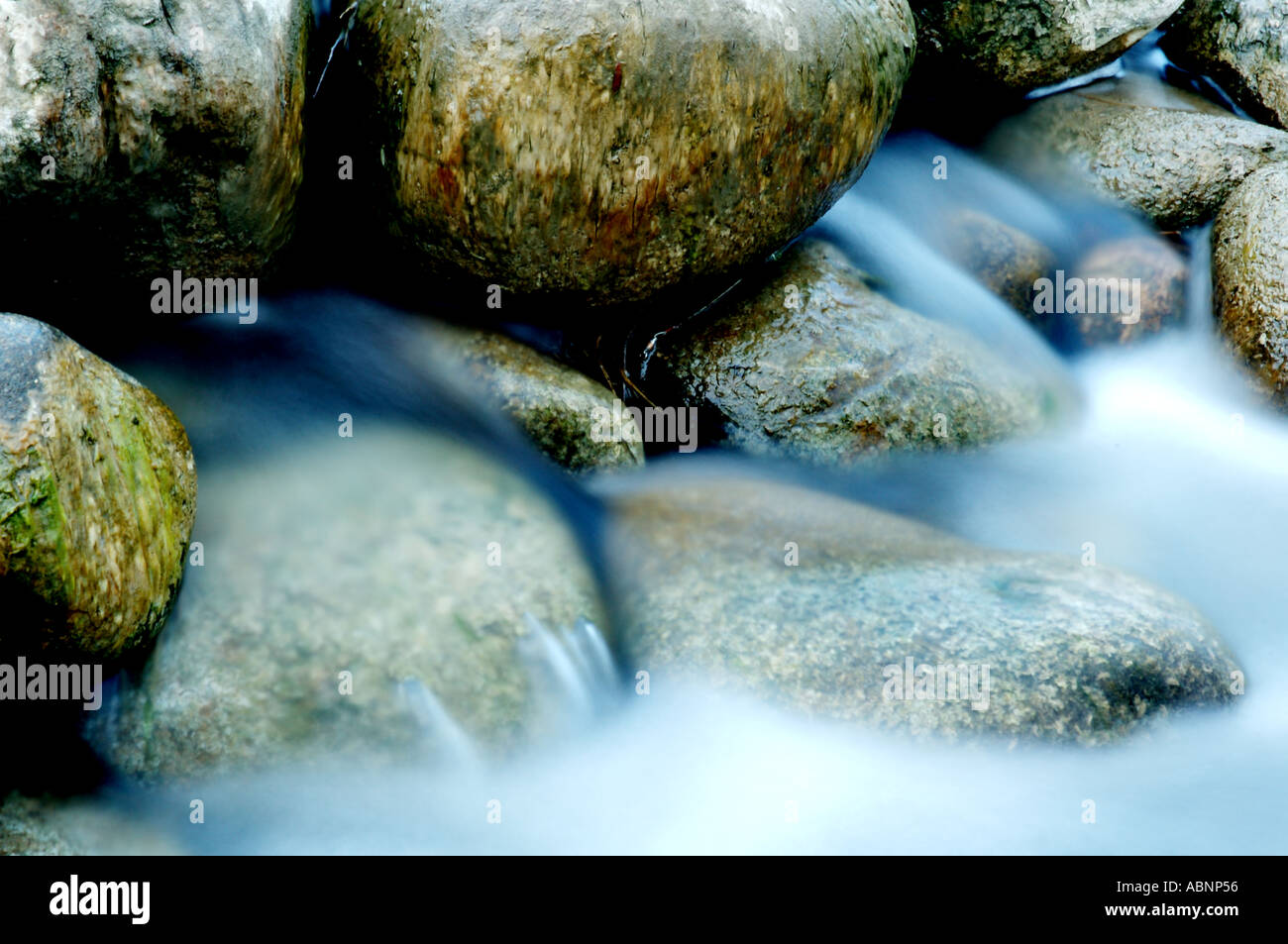 A closeup of rocks and water from a river flowing through them Stock ...
