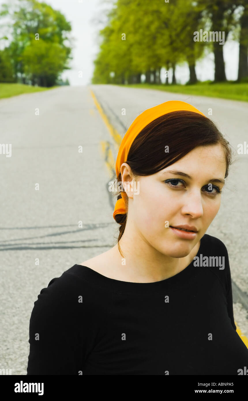 A woman sitting on the road this shot is a closeup of her face with the ...