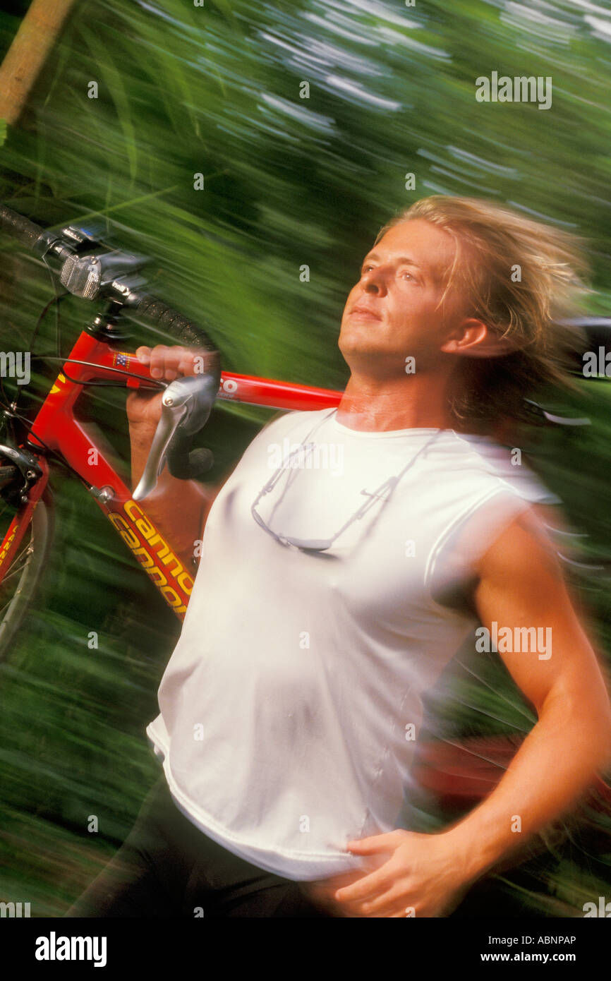 Man running with bicycle Stock Photo - Alamy