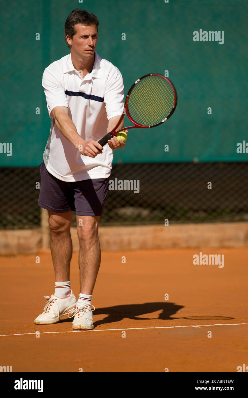 Male tennis player serving Stock Photo - Alamy