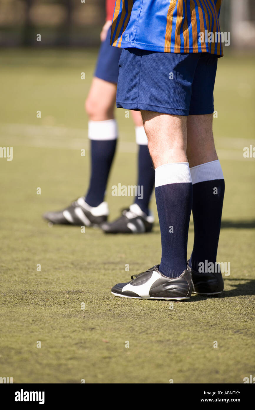 Soccer players standing on field Stock Photo - Alamy