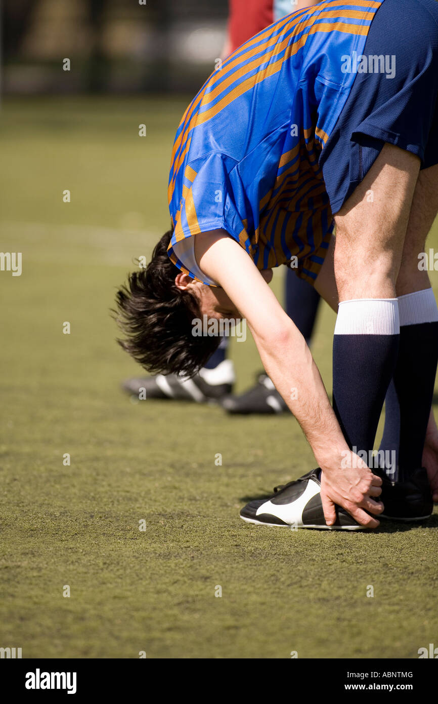 Soccer player stretching on field Stock Photo - Alamy