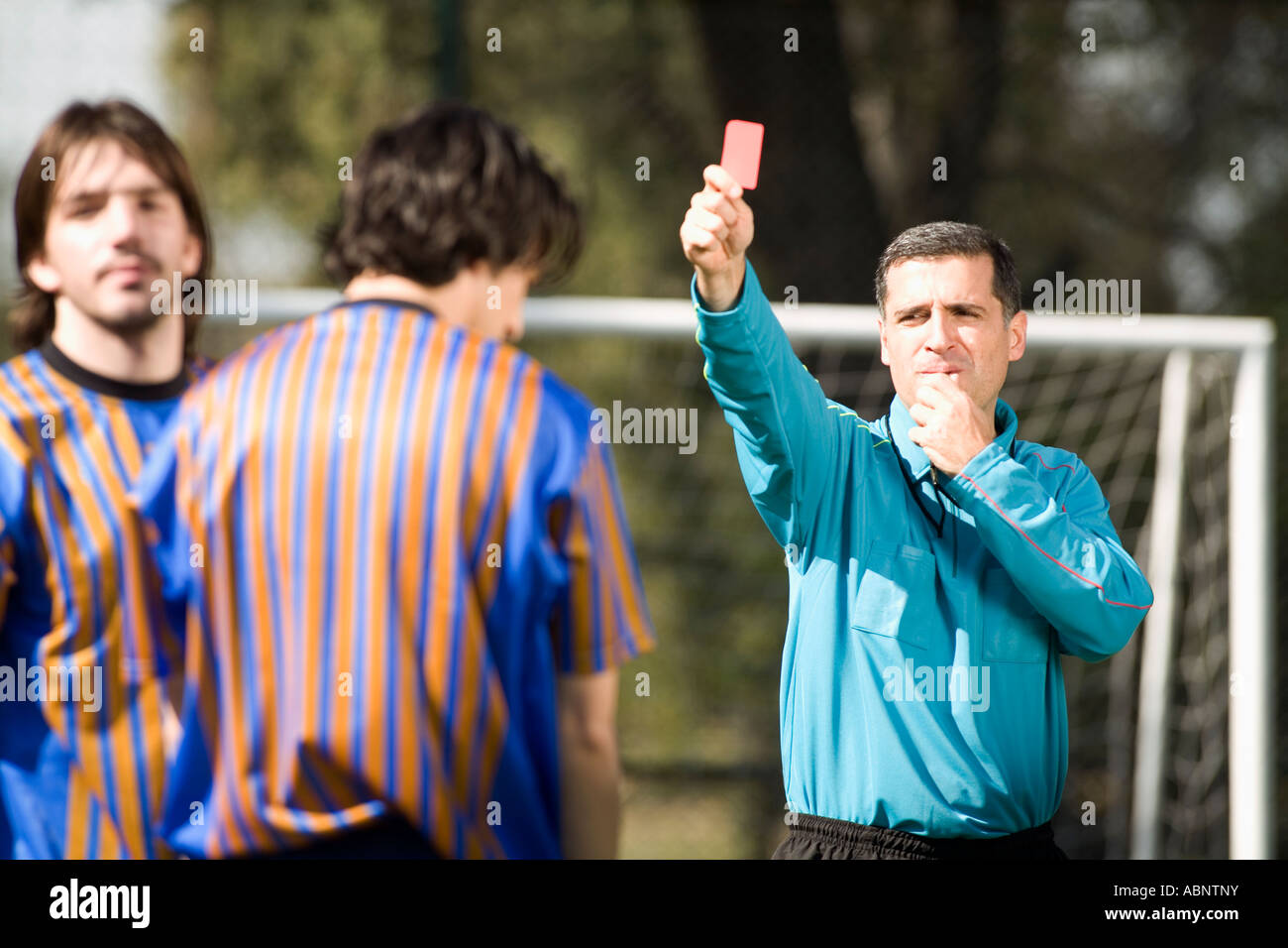 referee showing a soccer player the red card Stock Photo - Alamy