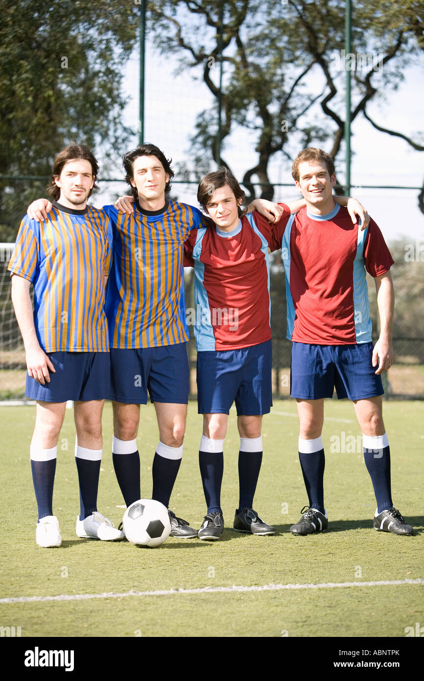 Male soccer players standing together on field Stock Photo - Alamy