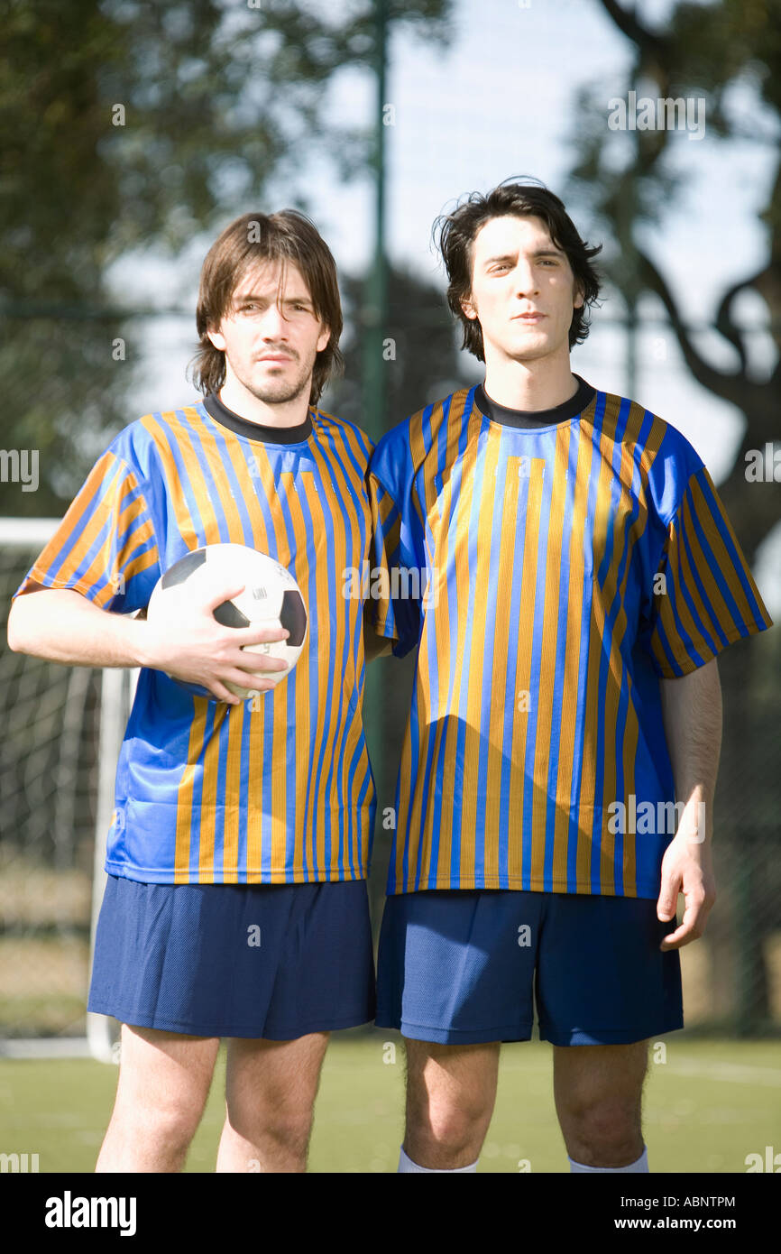 Male soccer players standing together on field Stock Photo - Alamy