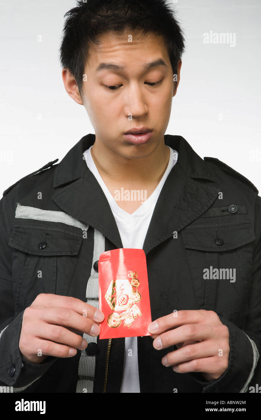 Man peering inside red packet Stock Photo - Alamy