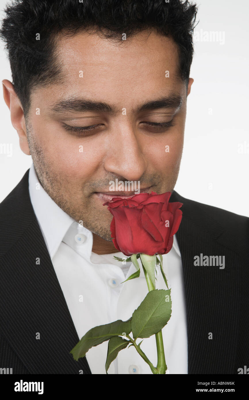 Man smelling a rose Stock Photo - Alamy