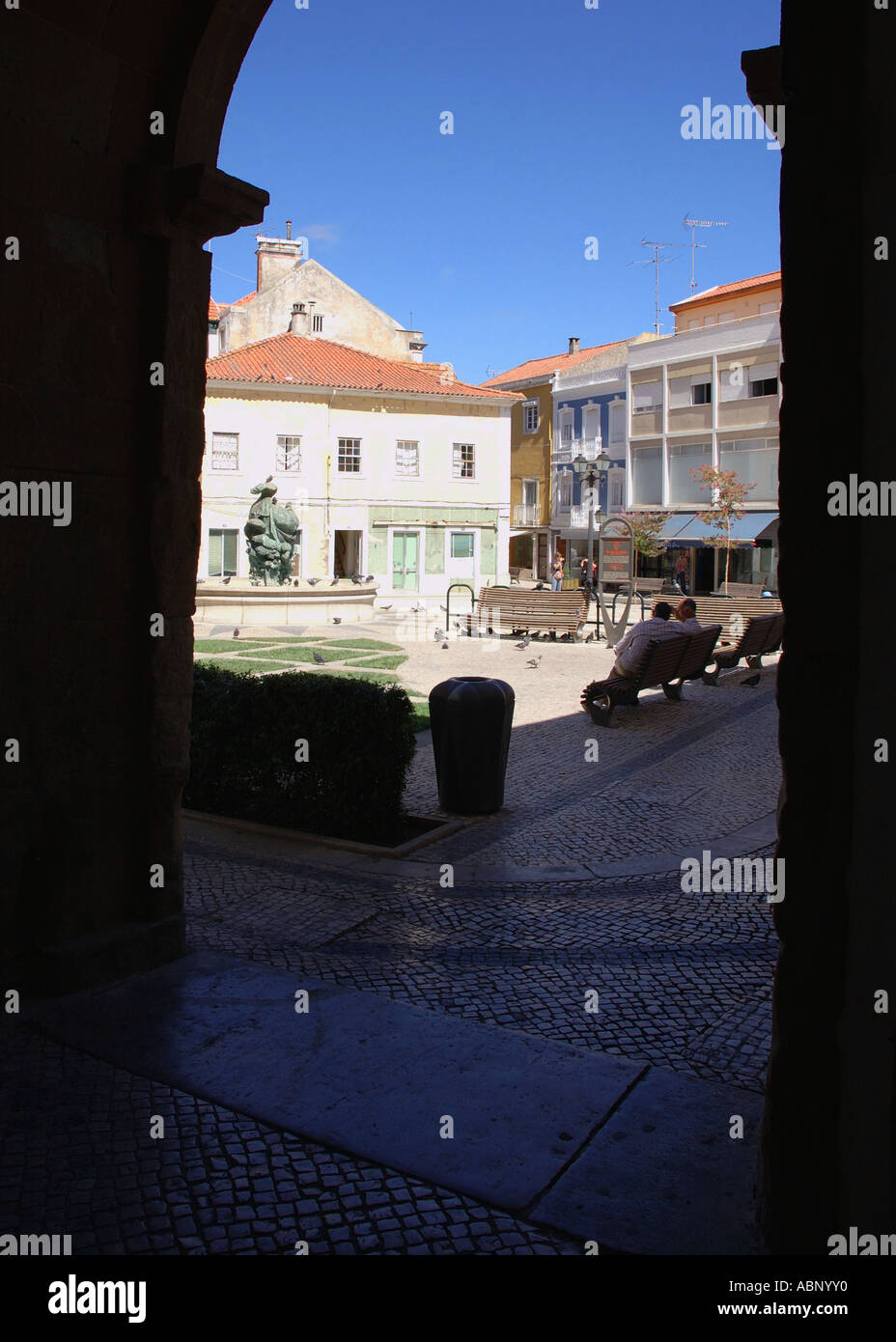 View through arch of little square in old town centre typical colourful ...