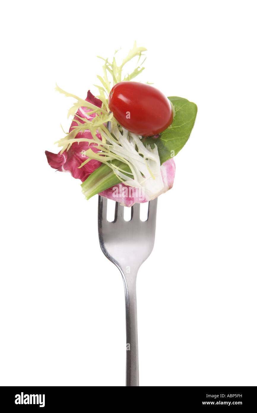 Salad on fork cut out on white background Stock Photo - Alamy