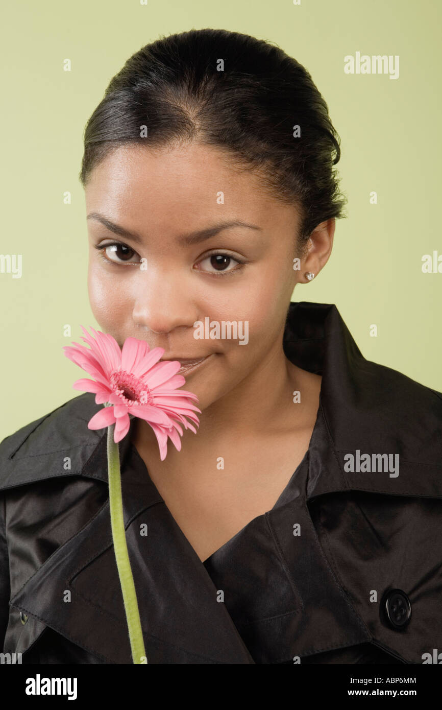 Woman smelling a flower Stock Photo - Alamy