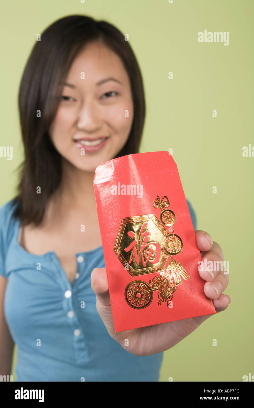 Woman offering red packet Stock Photo - Alamy