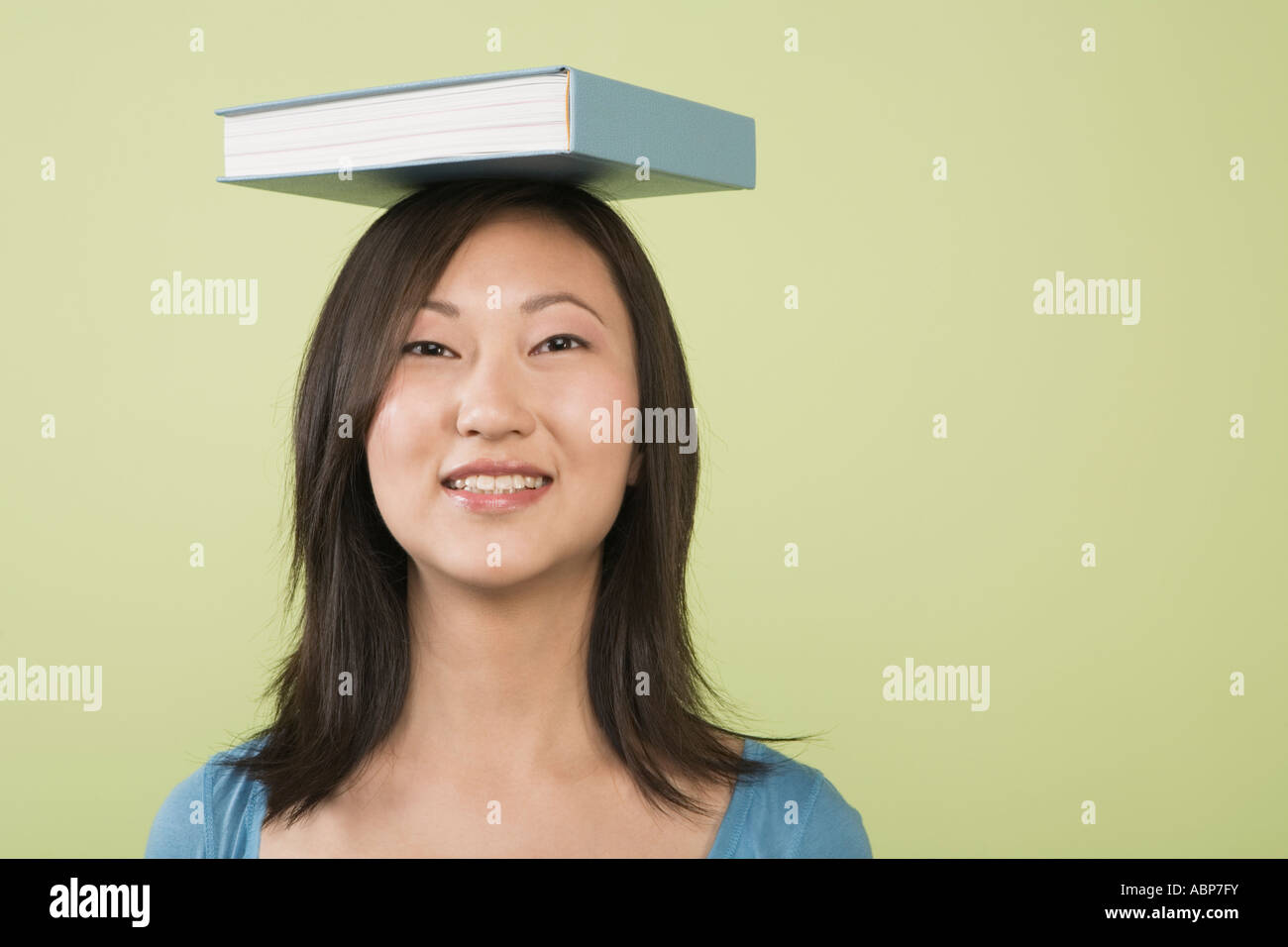 Woman balancing book on her head Stock Photo - Alamy