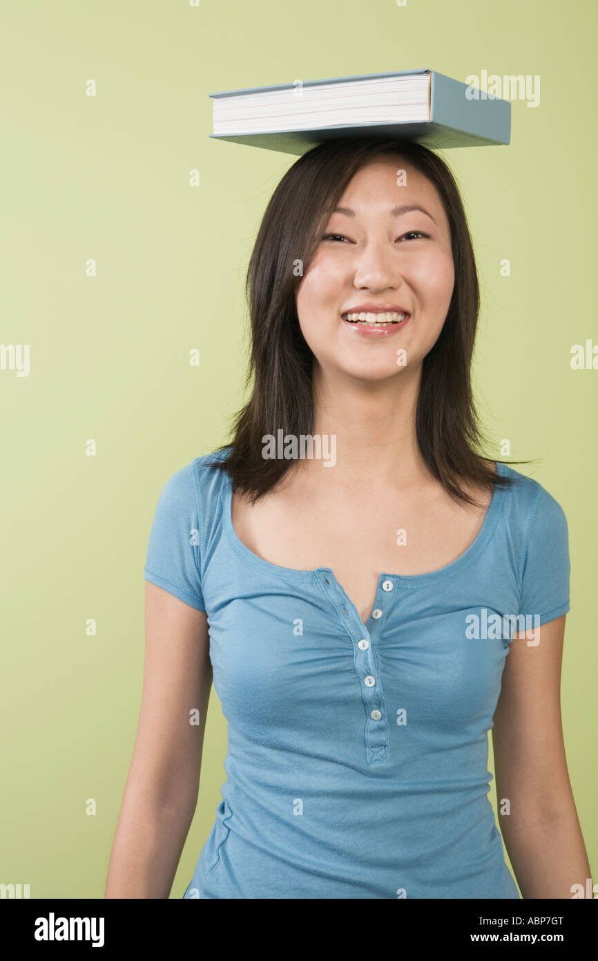 Woman balancing book on her head Stock Photo - Alamy
