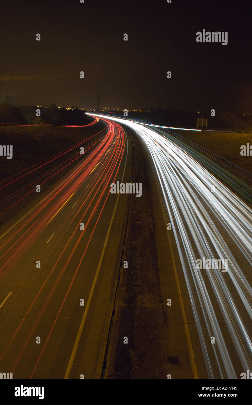 road at night time with cars going by Stock Photo - Alamy