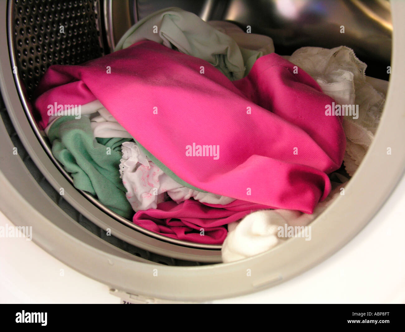 clothes in washing machine washed and spun dry ready for hanging out ...