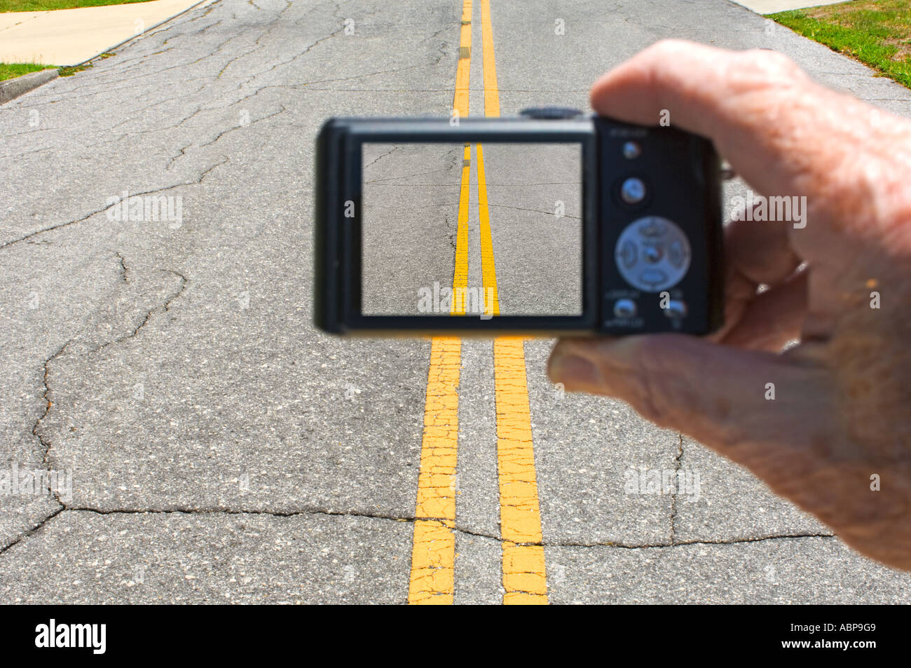 hand holding digital point and shoot camera showing yellow lines on ...