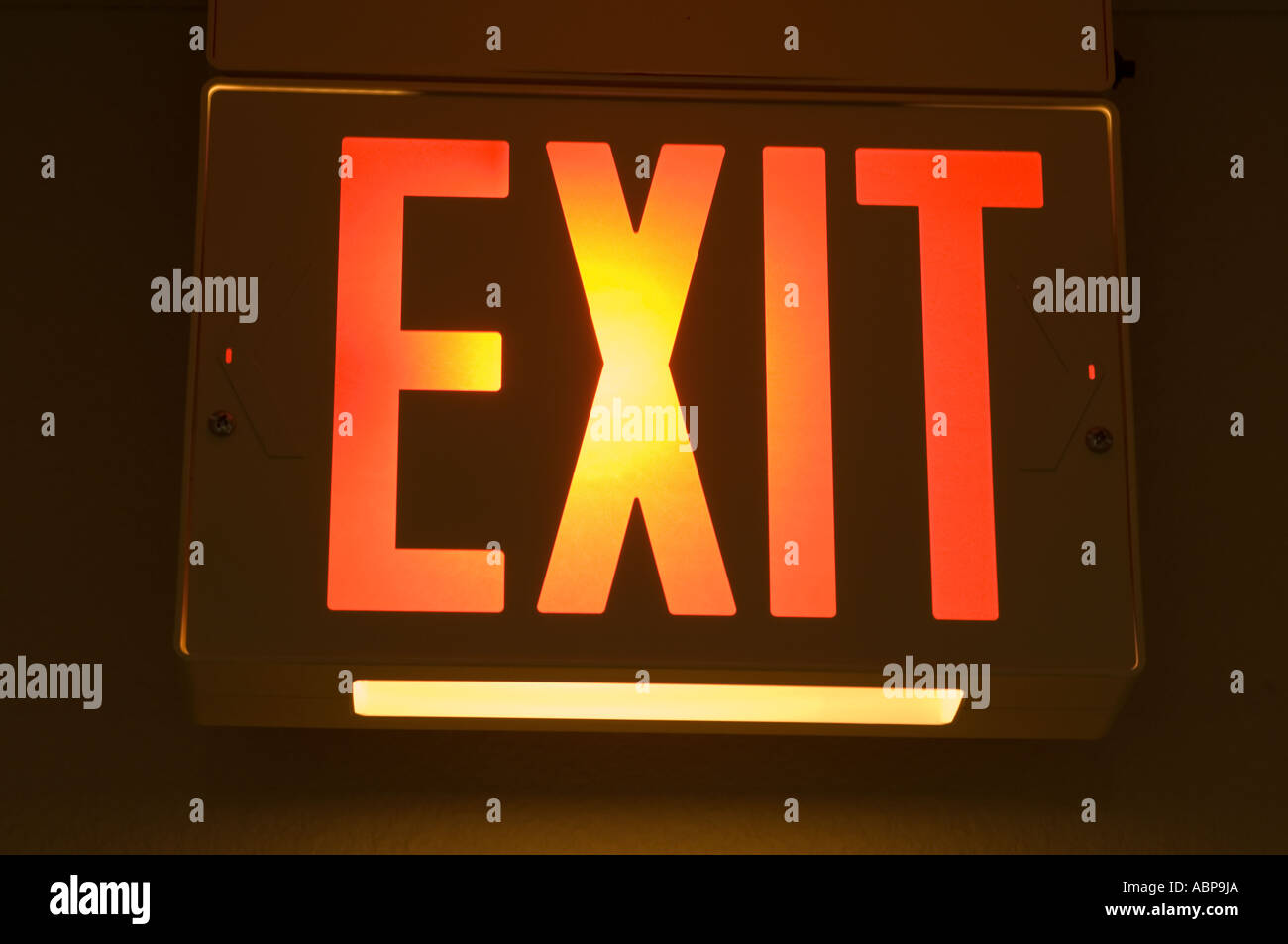 red glowing exit sign over doorway in office building Stock Photo - Alamy