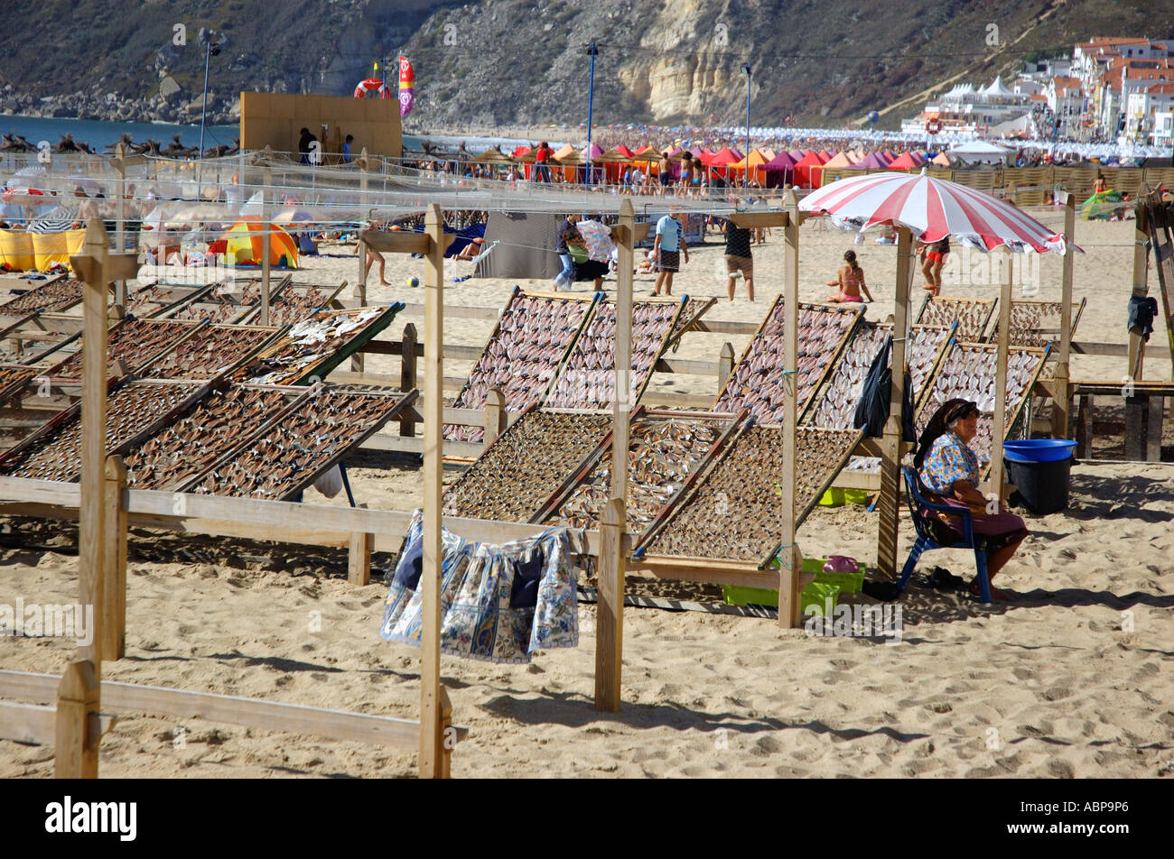 Panoramic view of the seafront and beach of Nazare with woman selling ...
