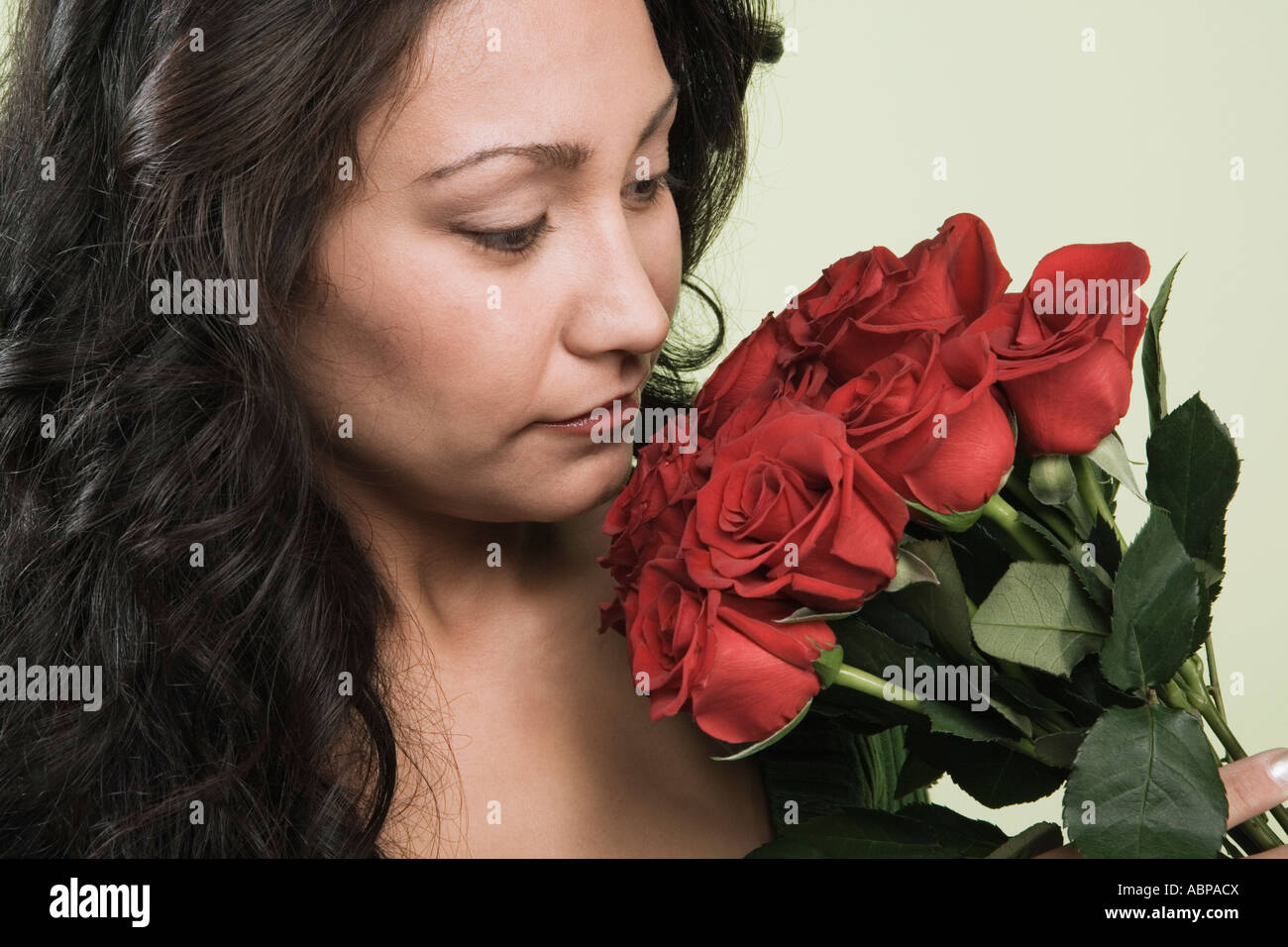 Woman smelling bouquet of roses Stock Photo - Alamy