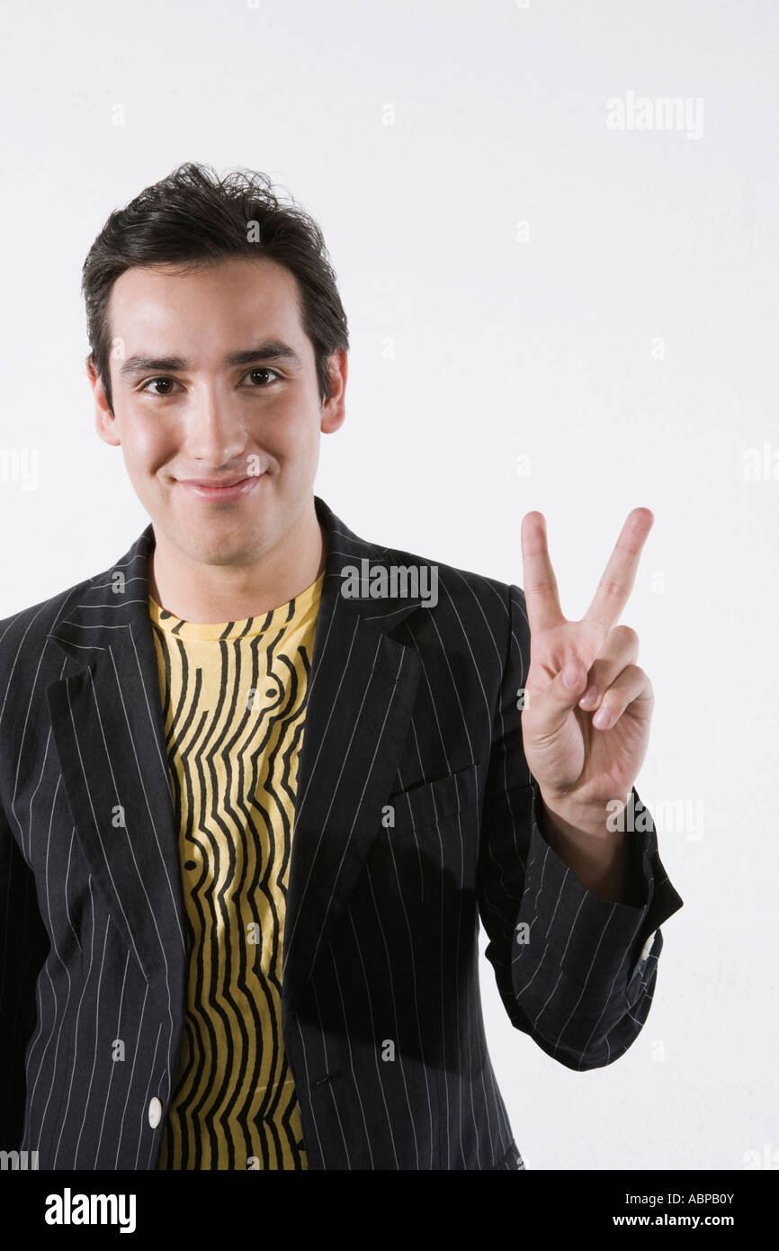 Man giving peace sign Stock Photo - Alamy