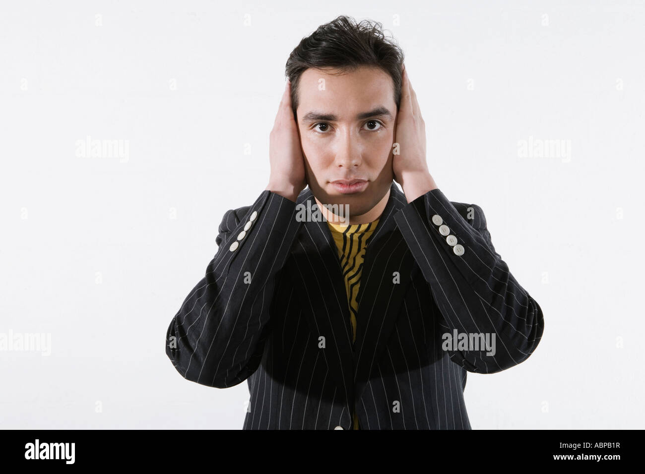 Man covering his ears Stock Photo - Alamy