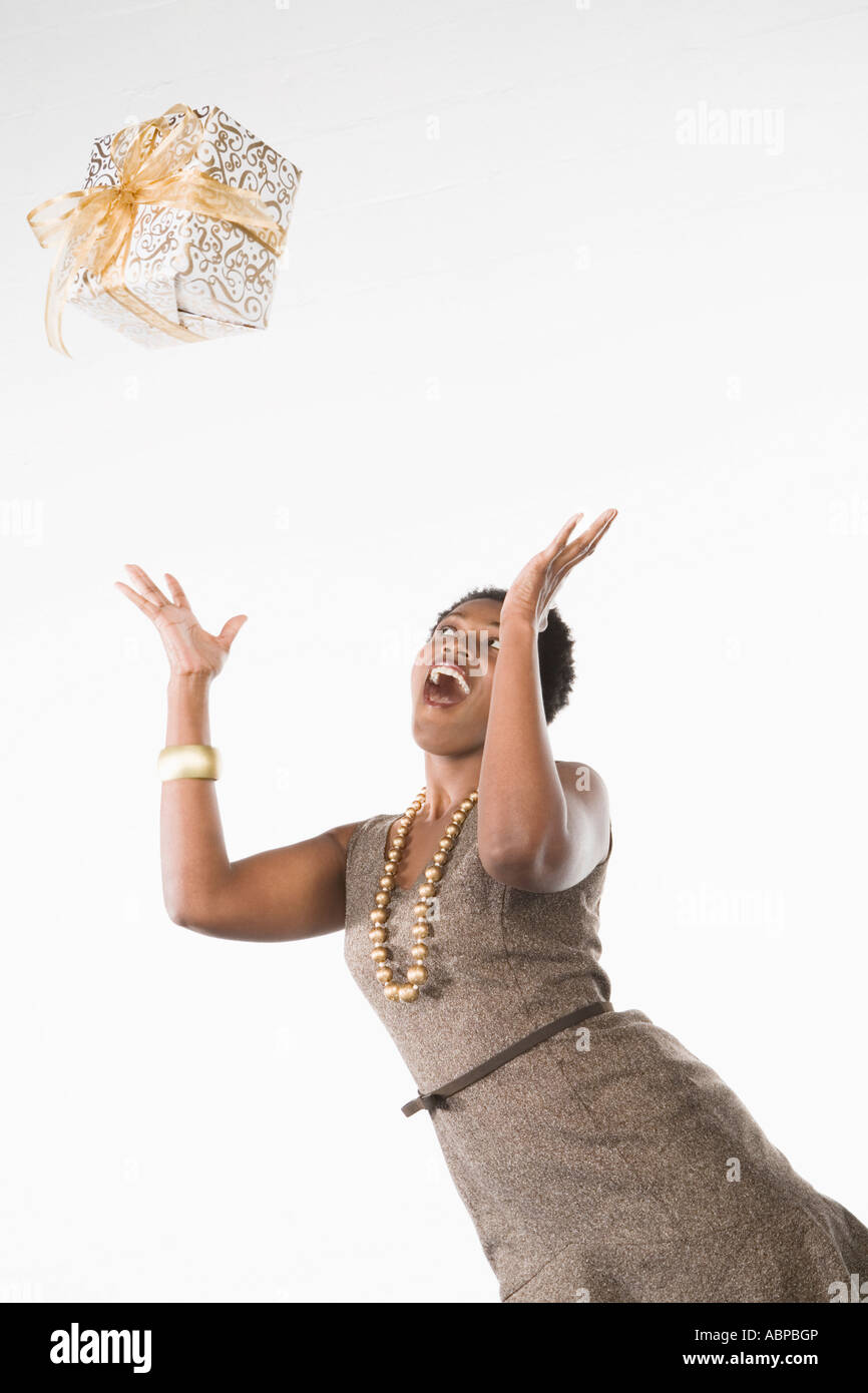 Woman tossing gift in the air Stock Photo - Alamy