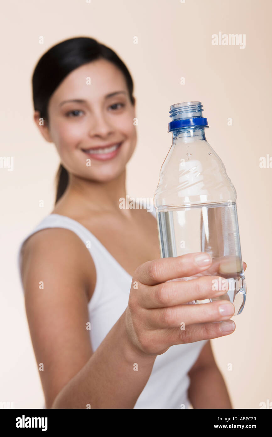 Woman offering water bottle Stock Photo - Alamy