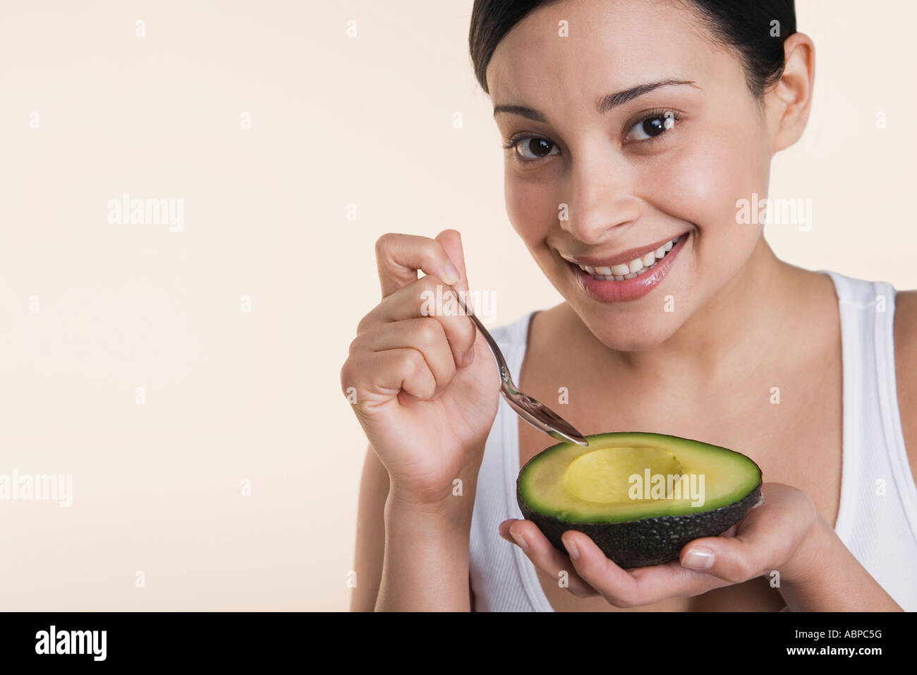 Woman eating avocado Stock Photo - Alamy