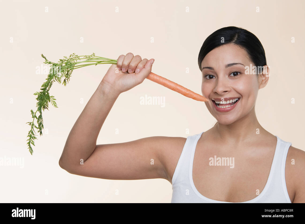 Woman eating carrot Stock Photo - Alamy