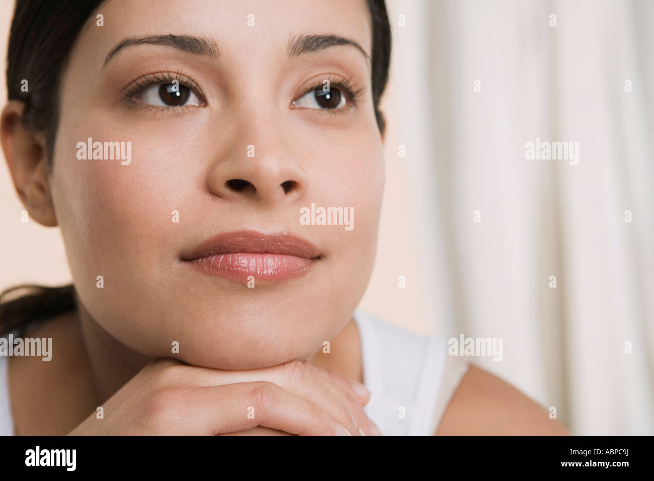 Woman resting chin on hands Stock Photo - Alamy