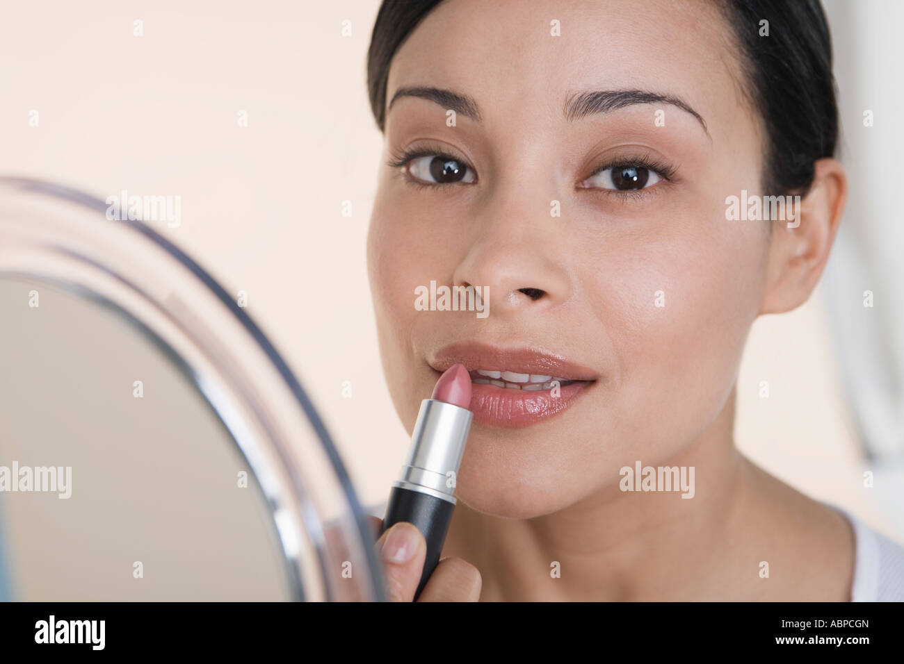 Woman applying lipstick Stock Photo - Alamy