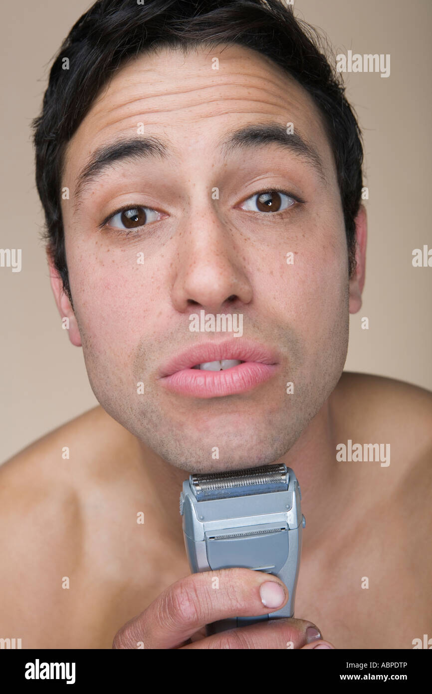 Man shaving with electric razor Stock Photo - Alamy