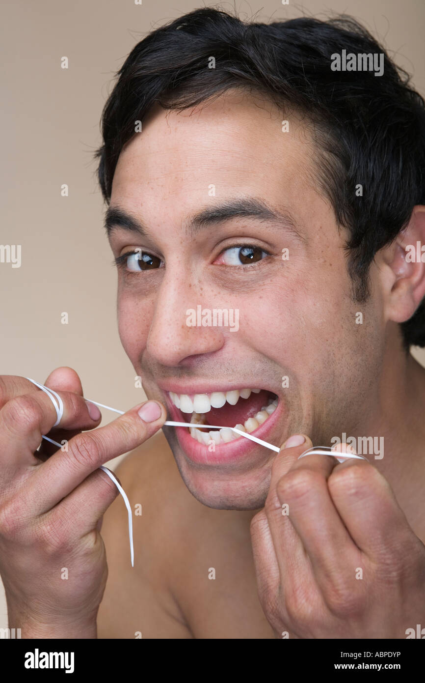 Man flossing his teeth Stock Photo - Alamy